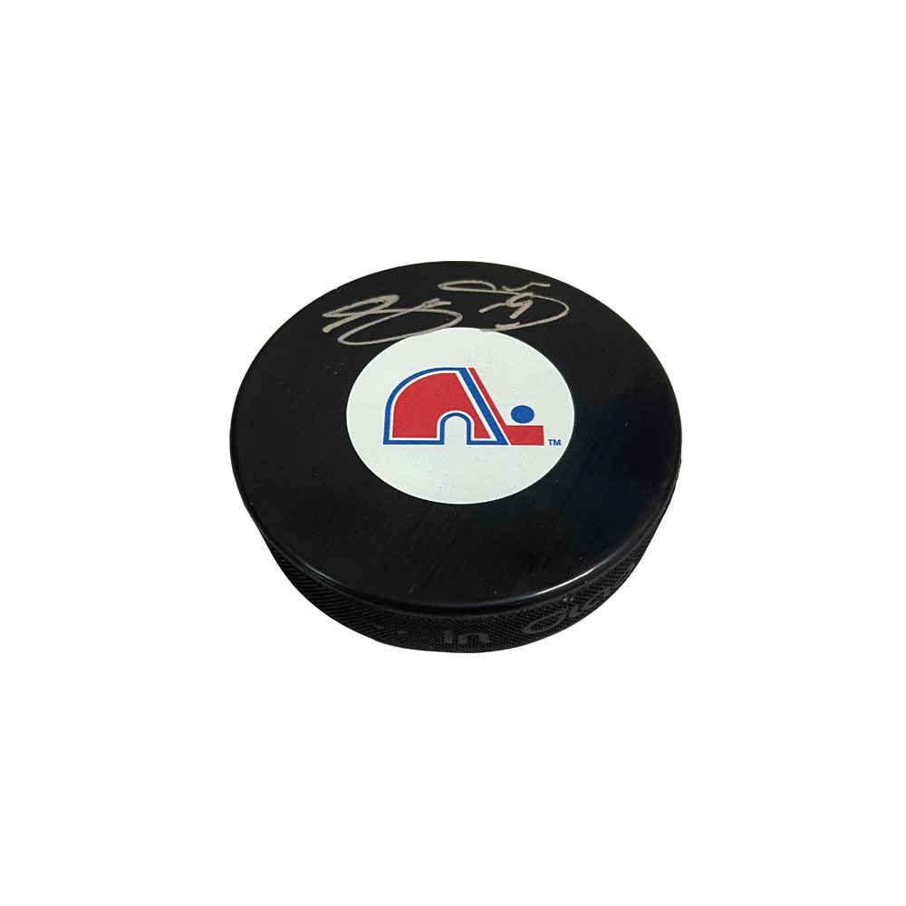 JOE SAKIC Signed Quebec Nordiques Puck (Exact Photo Shown) - NHL Auctions